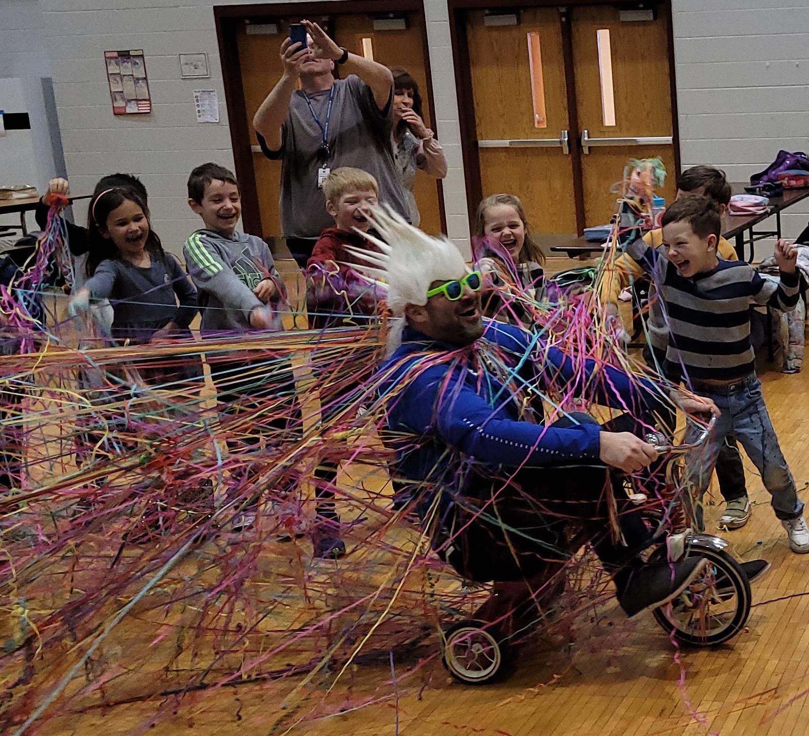 Geneva principal rides trike to reward students for fundraising goal ...