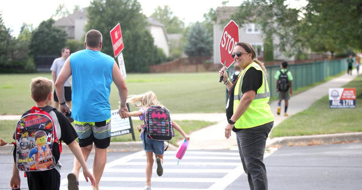 Administrators, police officers take on role of crossing guards at ...